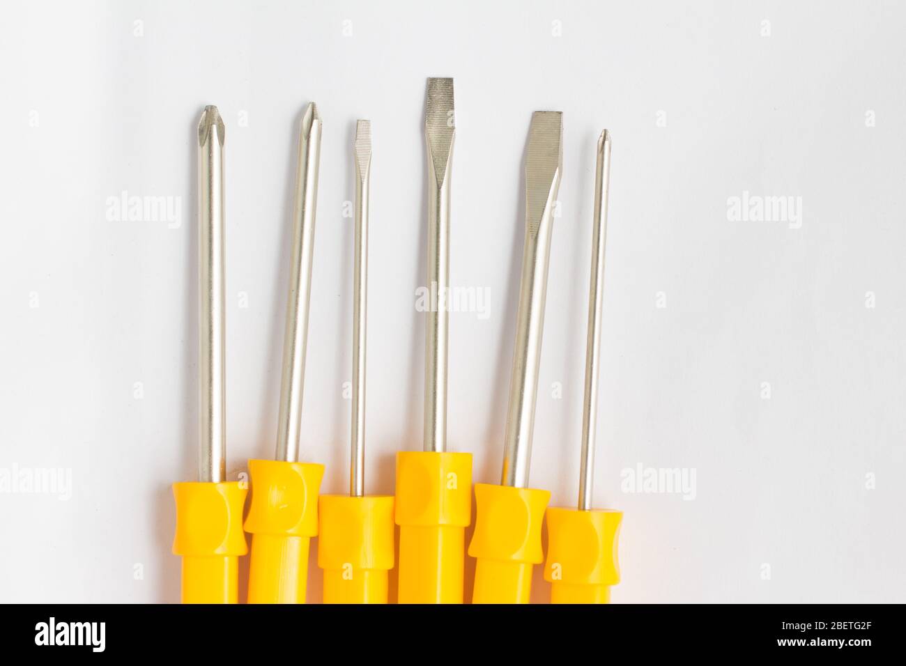 Six Yellow screwdriver on white background Stock Photo - Alamy