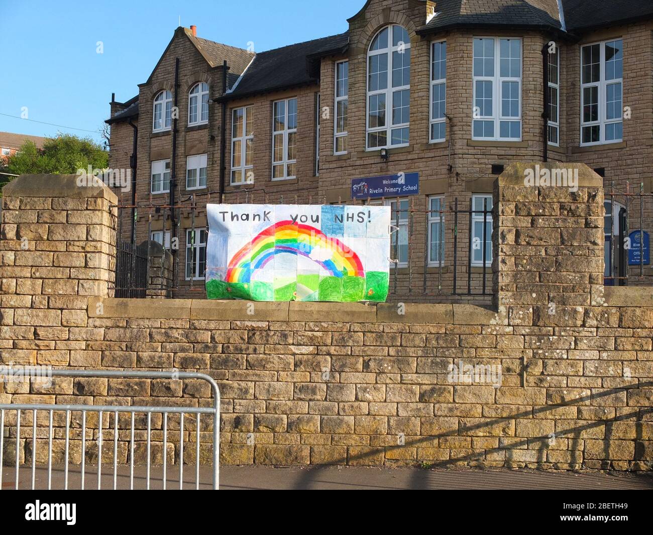 A rainbow sign with a message of gratitude to the NHS outside a school ...