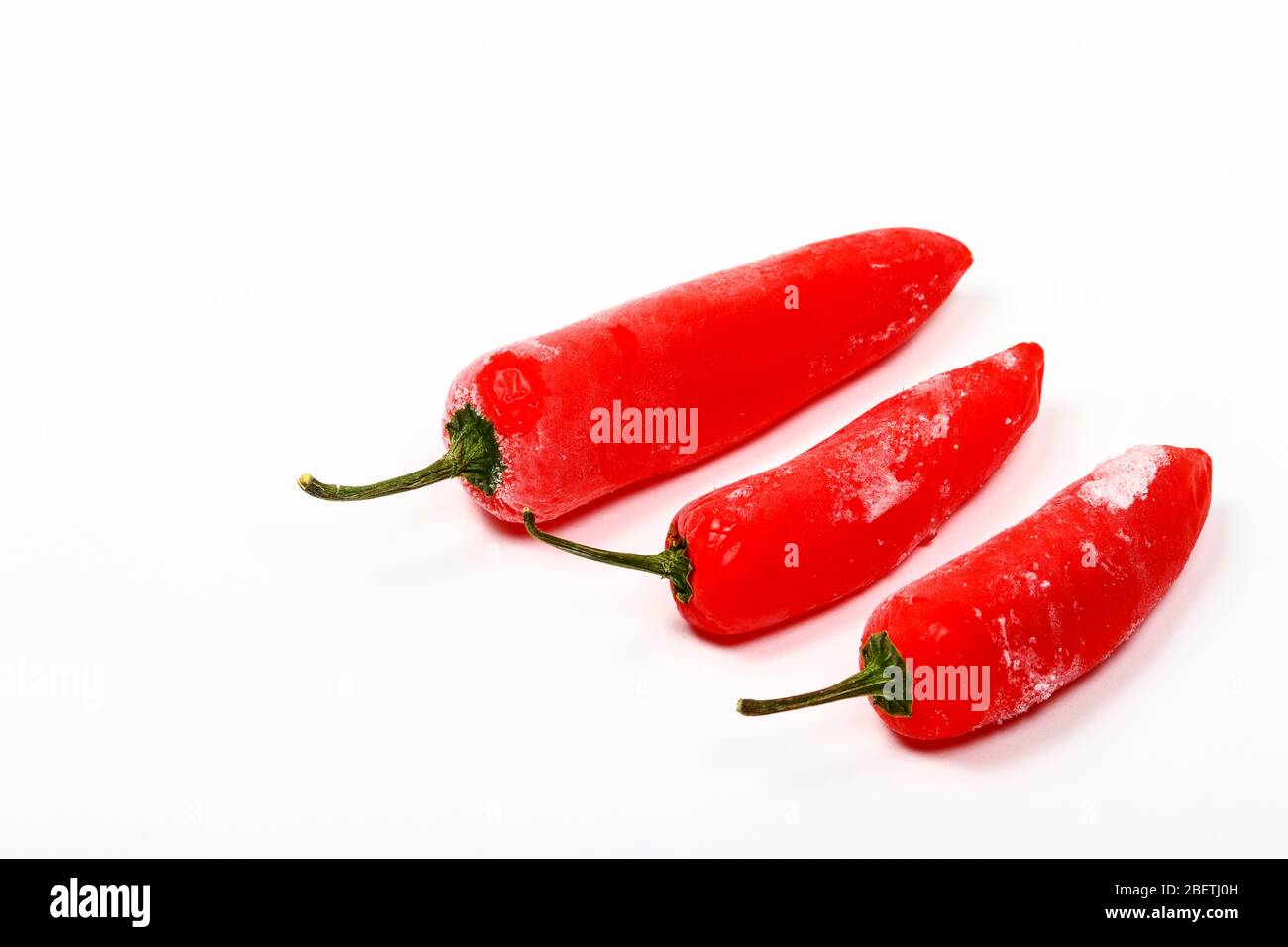 Red chilli peppers with ice crystals hot and cold concept Stock Photo ...