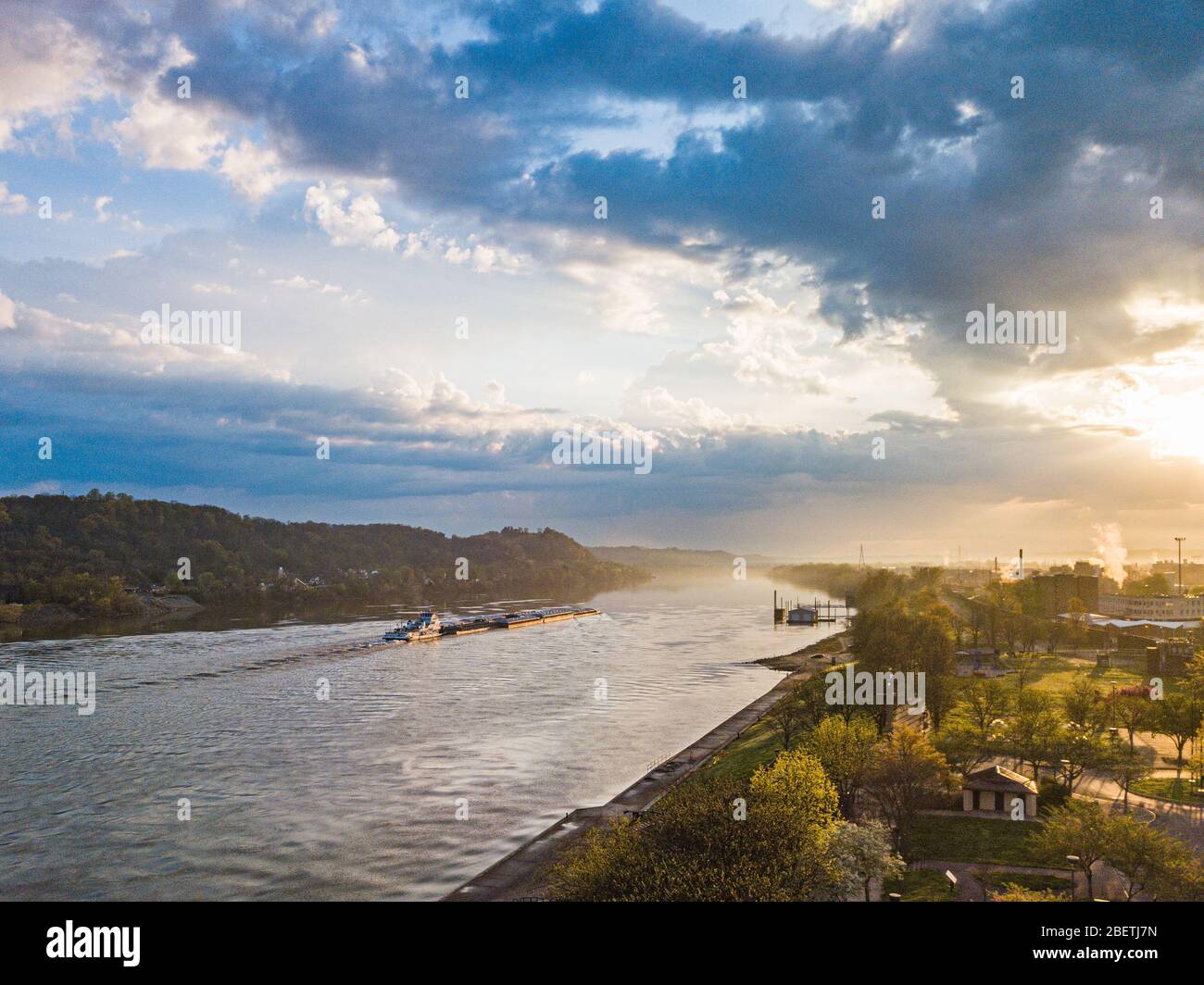 A coal barge passes down the Ohio River on an early morning surnise ...