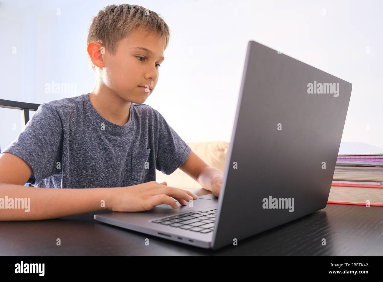 Preteen boy using laptop computer at home. Technology, online learning ...