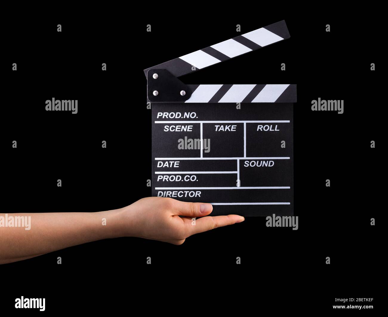 Human hand holding film clapper board isolated on black background ...