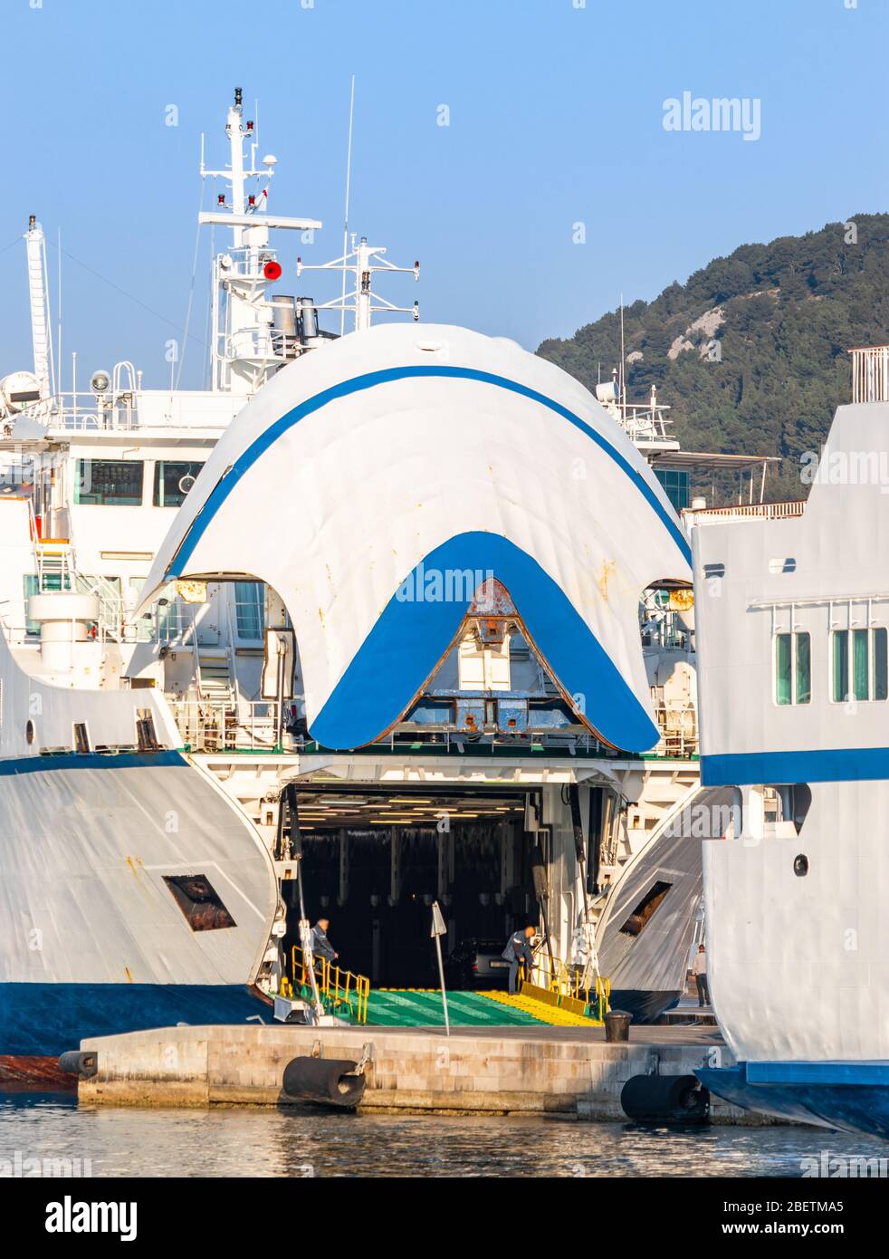 Inter-island ferry with it's entrance opened loading cars in a dock in ...