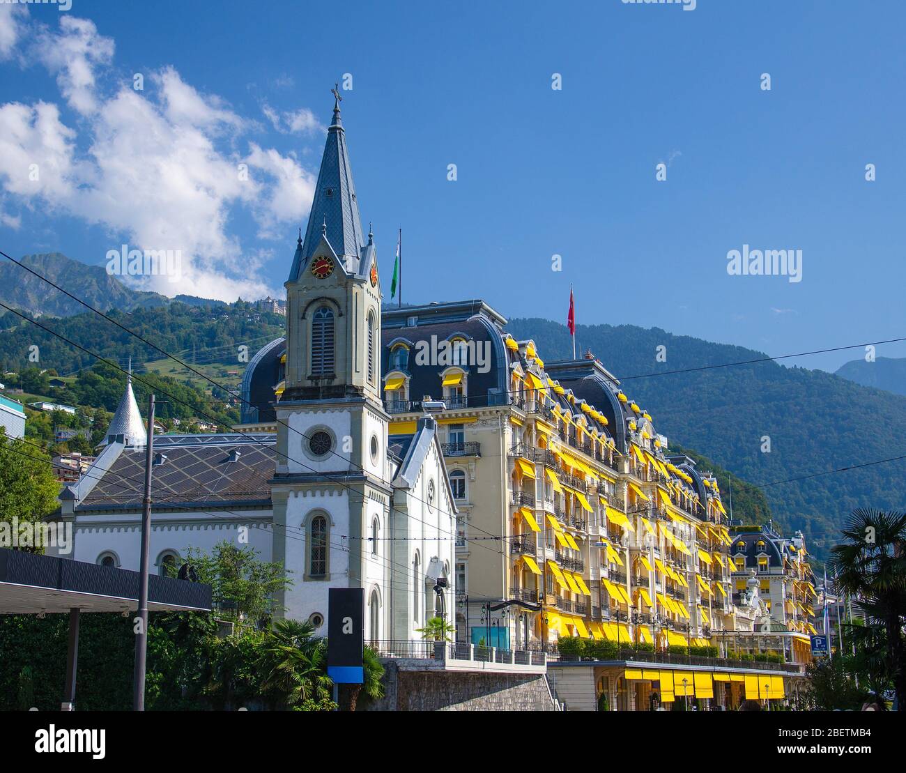 Church and Beautiful white multi-storey building with balconies and ...