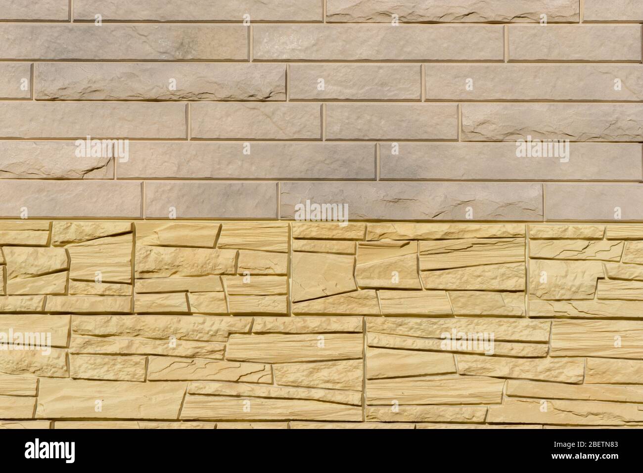 Cladding wall made of natural stone panels in pastel colors. Coverage ...