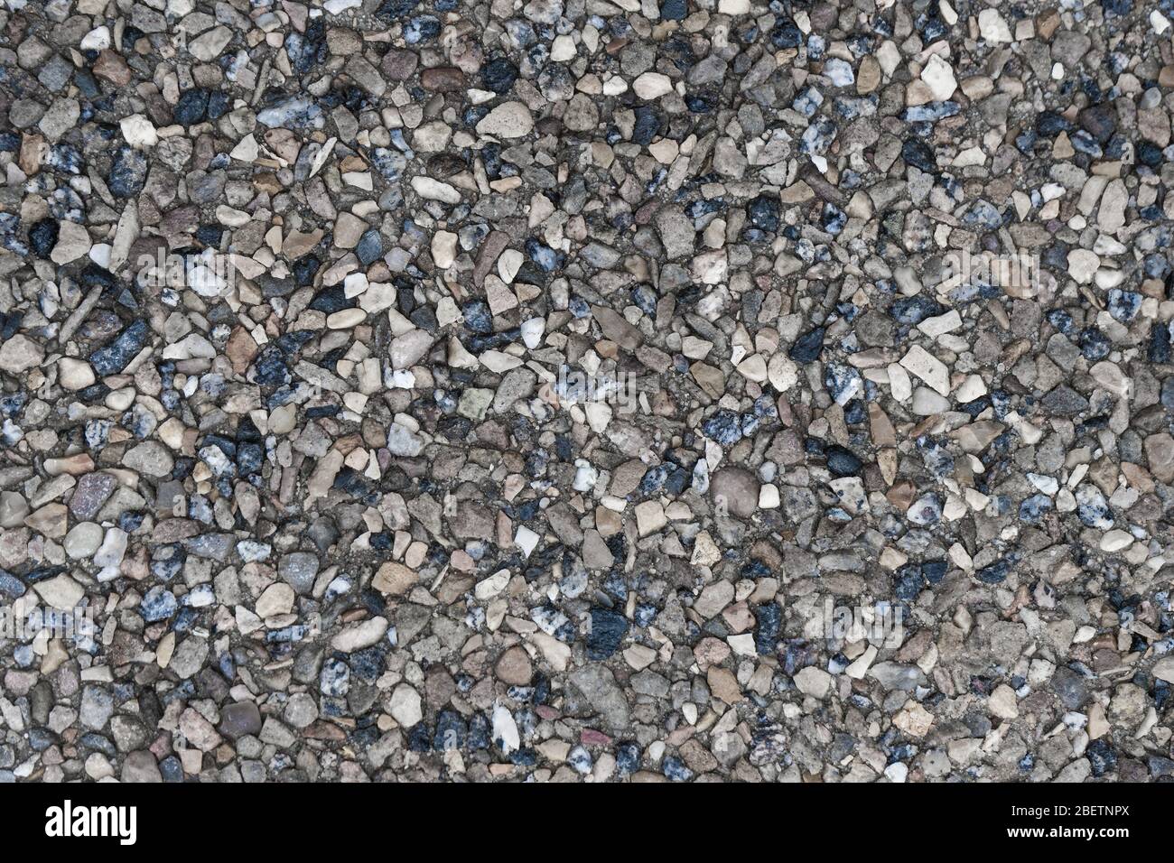 Crushed rubble and stones, granite chips closeup. Rough granular ...
