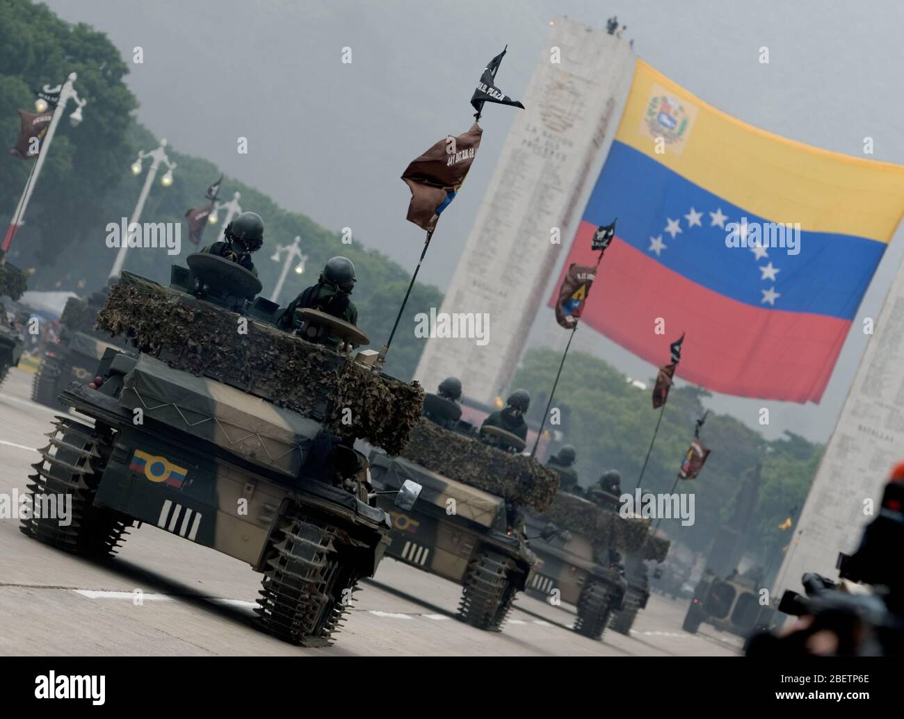 Venezuelan Army armored vehicles with the Venezuelan flag in background ...