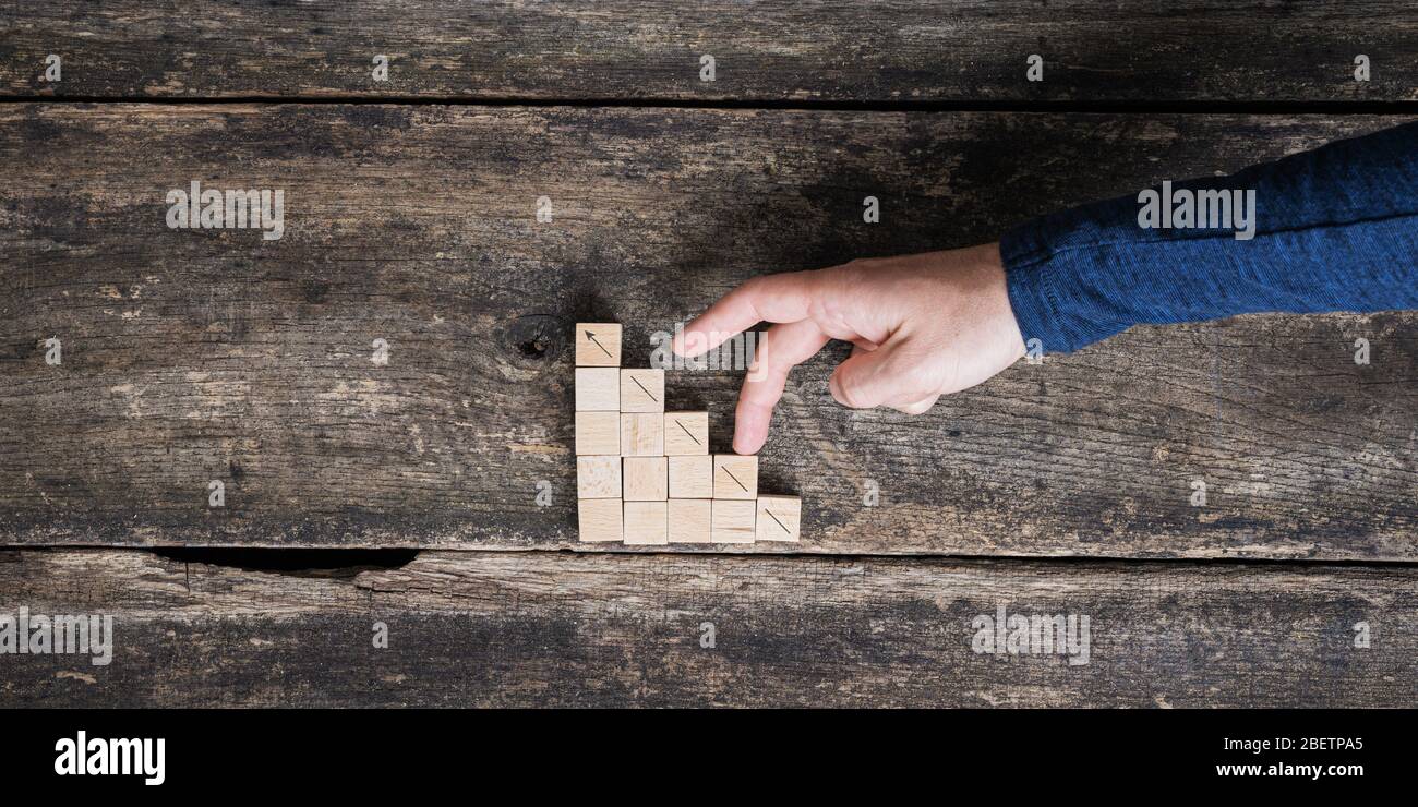 Top view of male hand walking his fingers up the steps with arrow ...