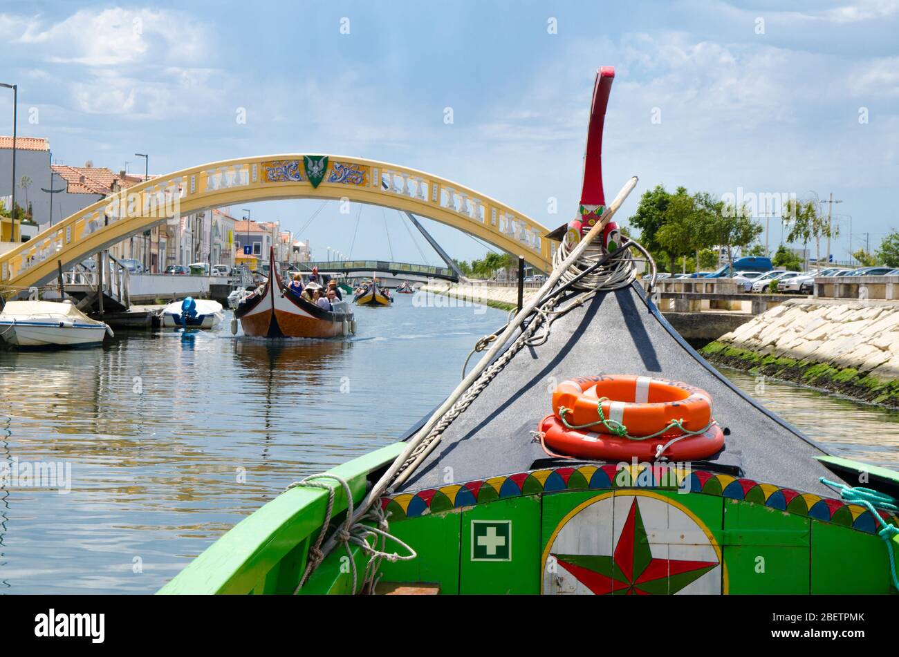 Traditional colorful boat Moliceiro on canal at the city of Aveiro ...