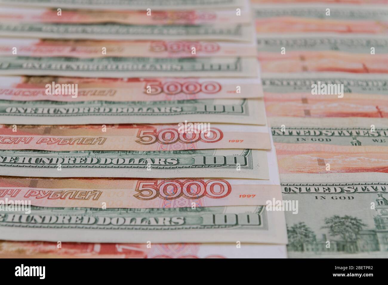 A large number of American hundred dollar bills and Russian five thousand dollar bills Stock ...