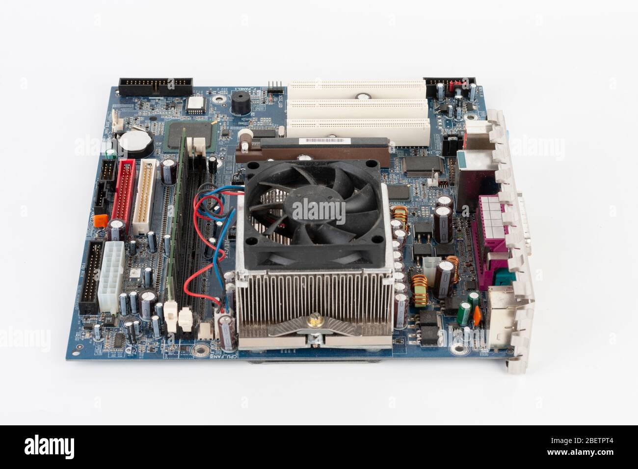 Main board of desktop computer, CPU cooler fan, memory module in slot ...