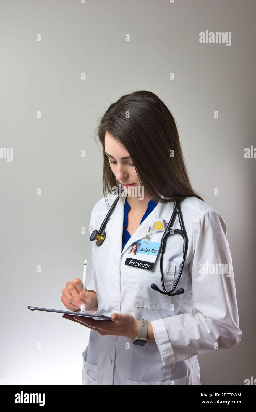 Doctor writing in patient chart hi-res stock photography and images - Alamy