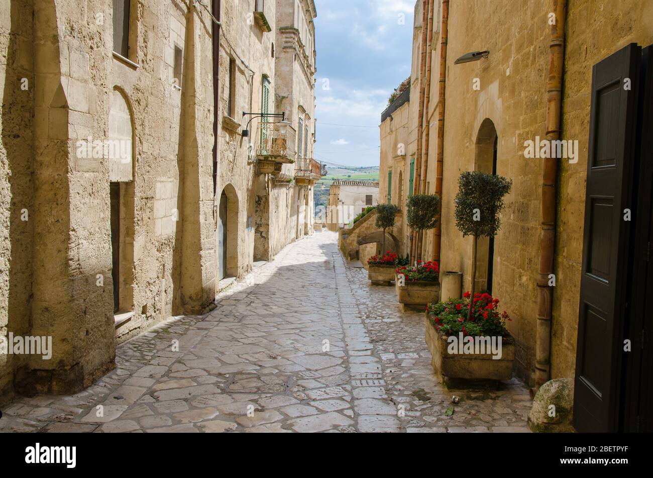 Narrow stone streets with flowers in Matera historical centre Sasso ...
