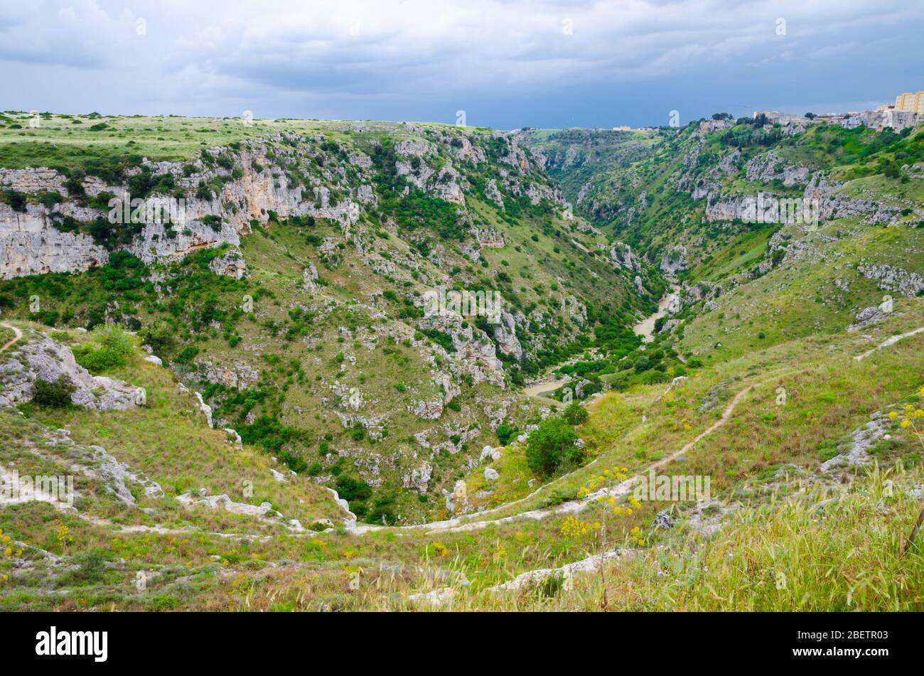 View of river valley with ravine canyon, rocks, green grass, path ...
