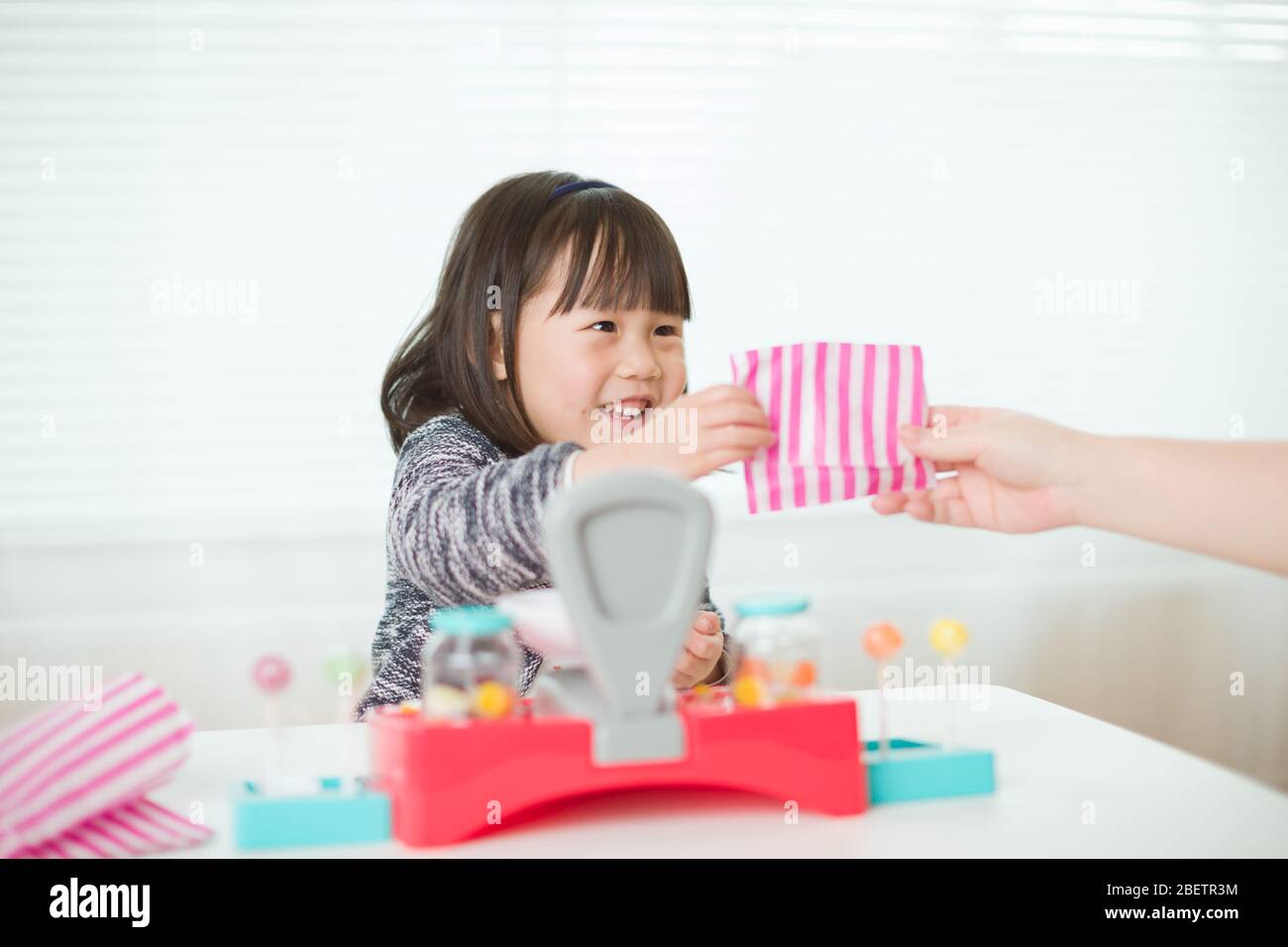 toddler girl pretend play sweet shop keeper at home Stock Photo - Alamy