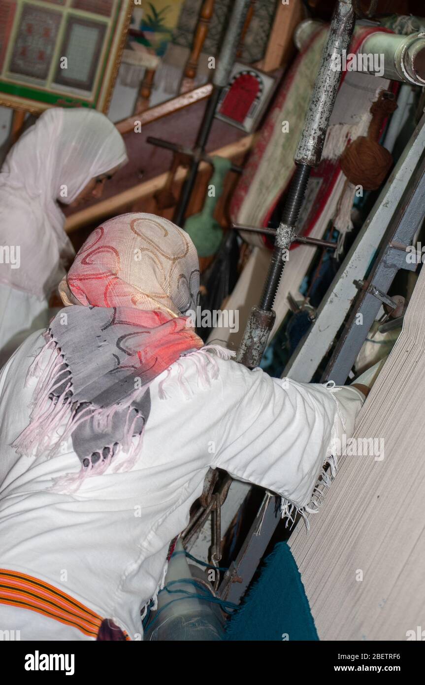 Berber woman weaving traditional rug hi-res stock photography and ...