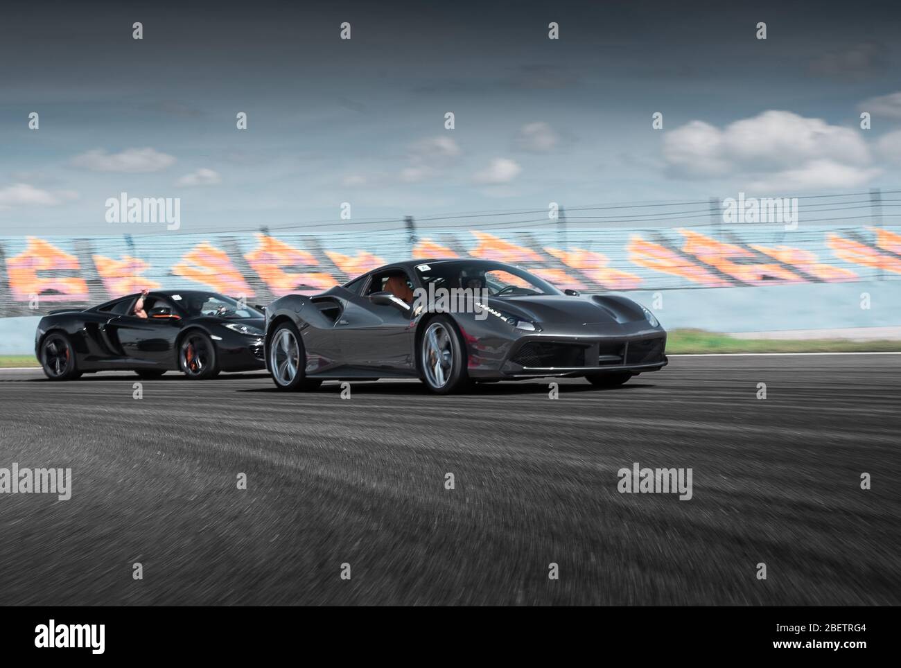 Two black sport cars on the racing trace Stock Photo - Alamy