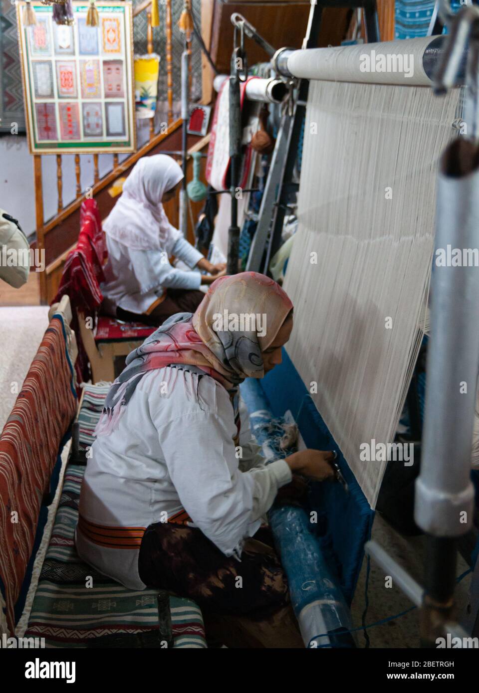 Berber woman weaving traditional rug hi-res stock photography and ...