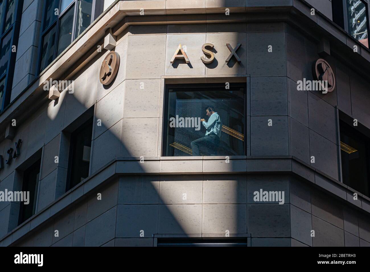 A man at the window talking on the phone at ASX Australian Securities ...