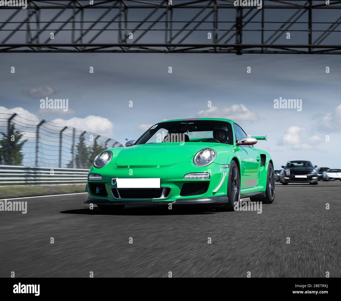 Green sport car on the racing trace Stock Photo - Alamy