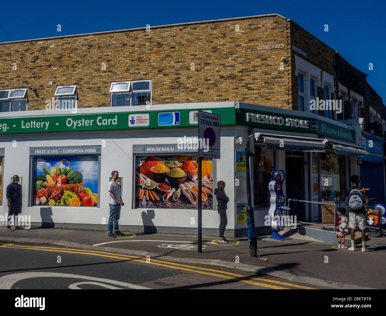 London. UK. April the 5th, 2020. View of people queuing in a shop in ...