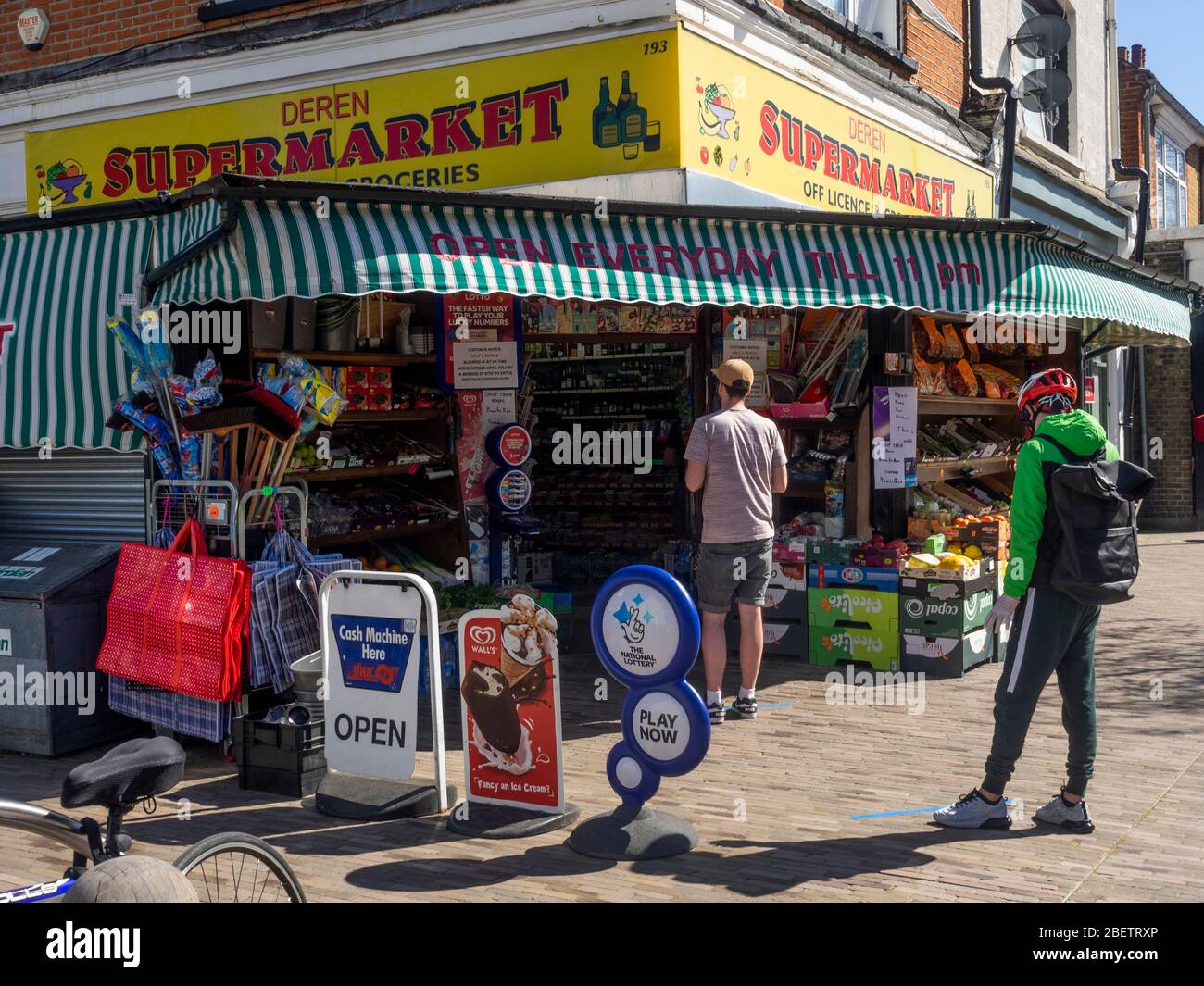 London. UK. April the 5th, 2020. View of people queuing in a shop in ...