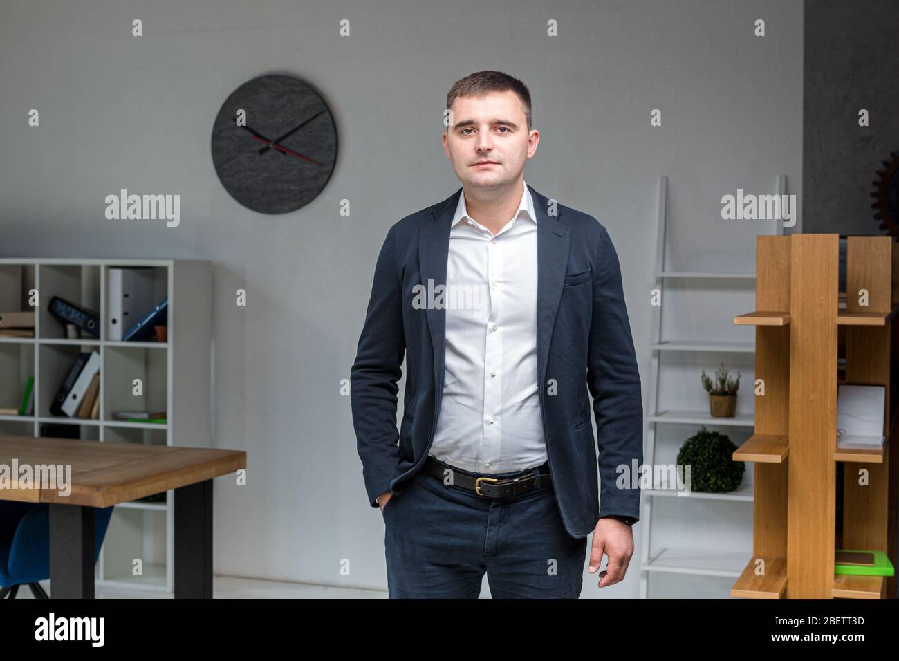 Portrait of a Caucasian male indoors posing in a jacket and white shirt ...