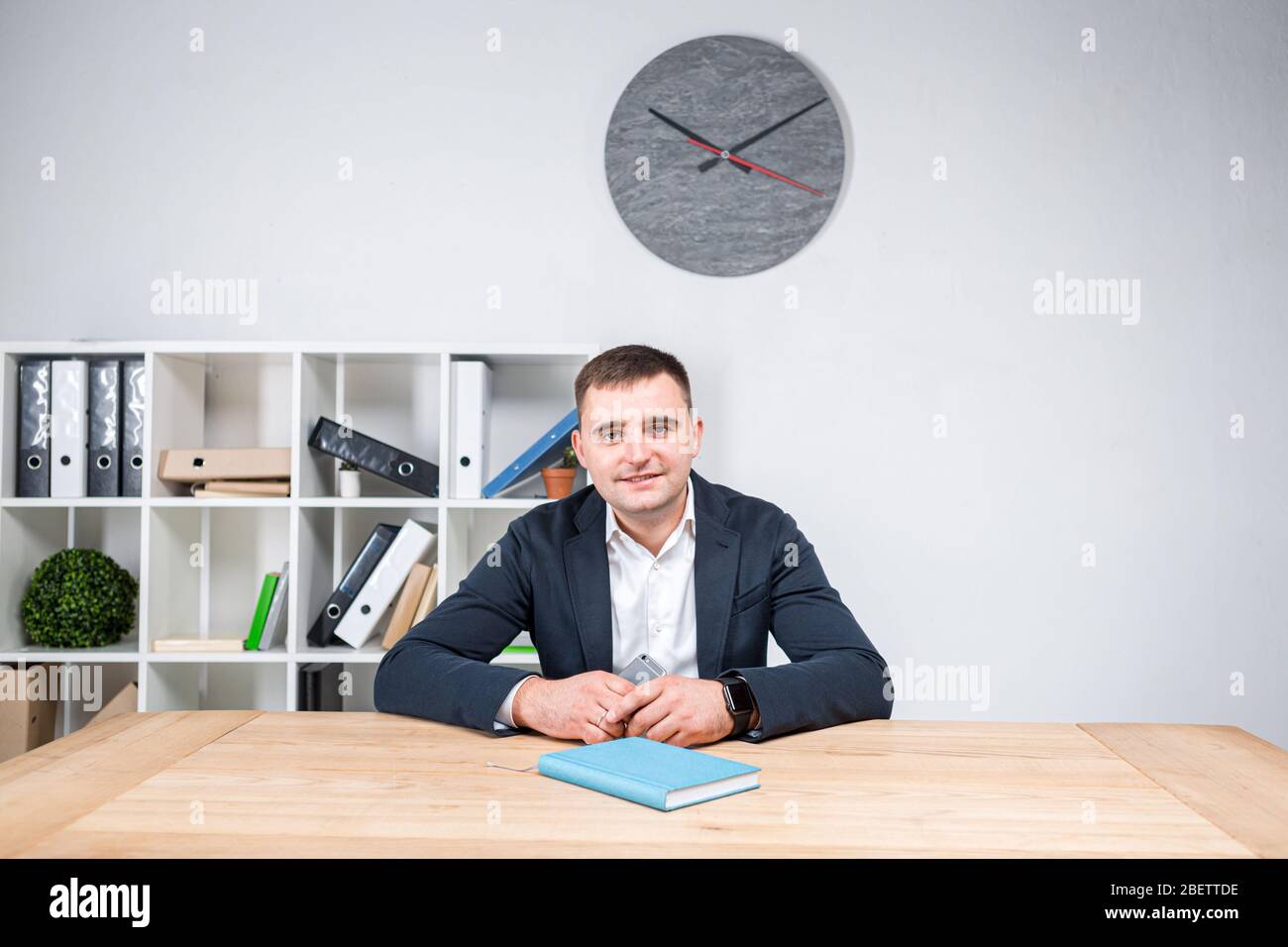 Portrait of a Caucasian male indoors posing in a jacket and white shirt ...