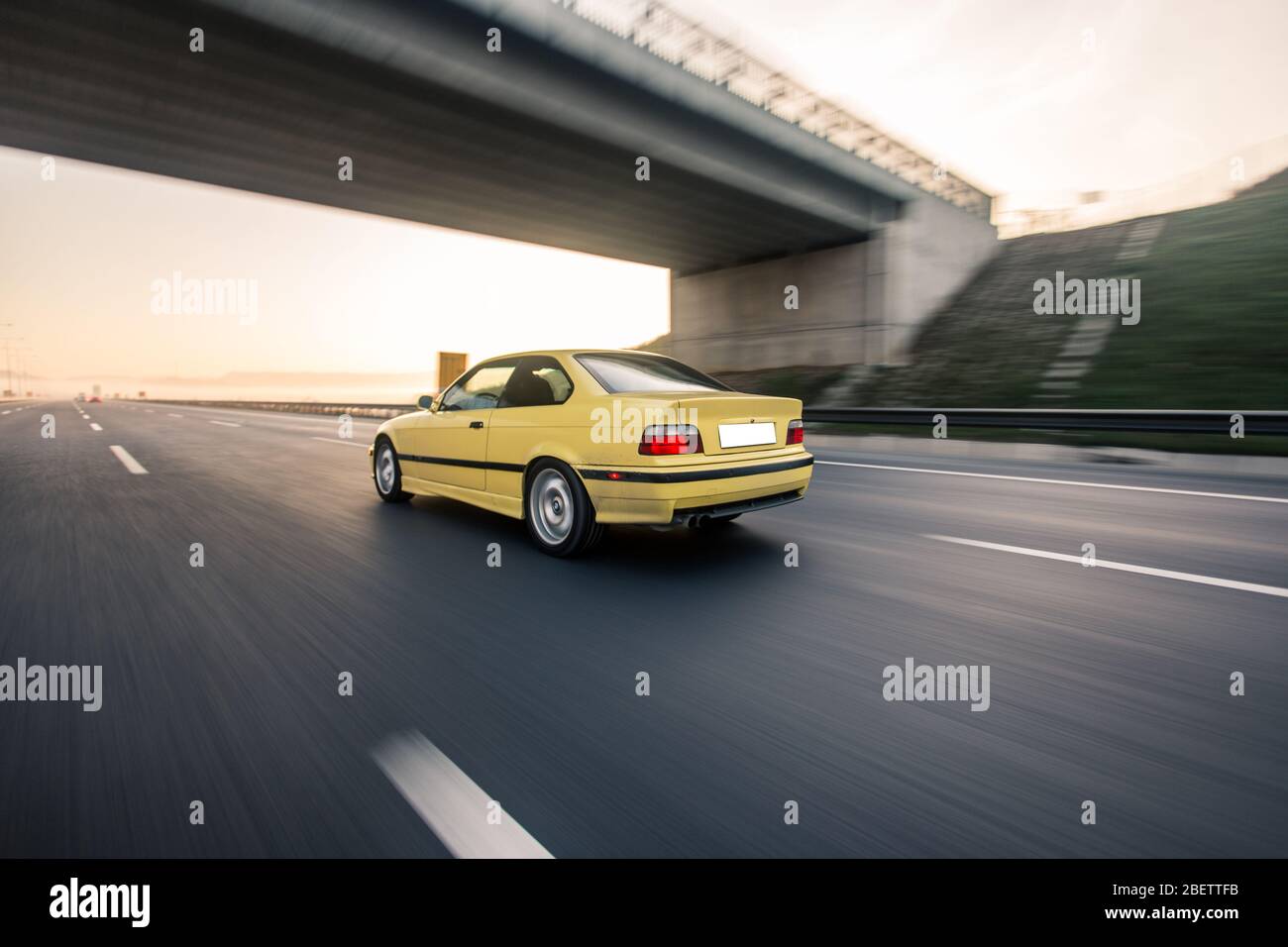Traditional taxi cab driving under the bridge Stock Photo - Alamy