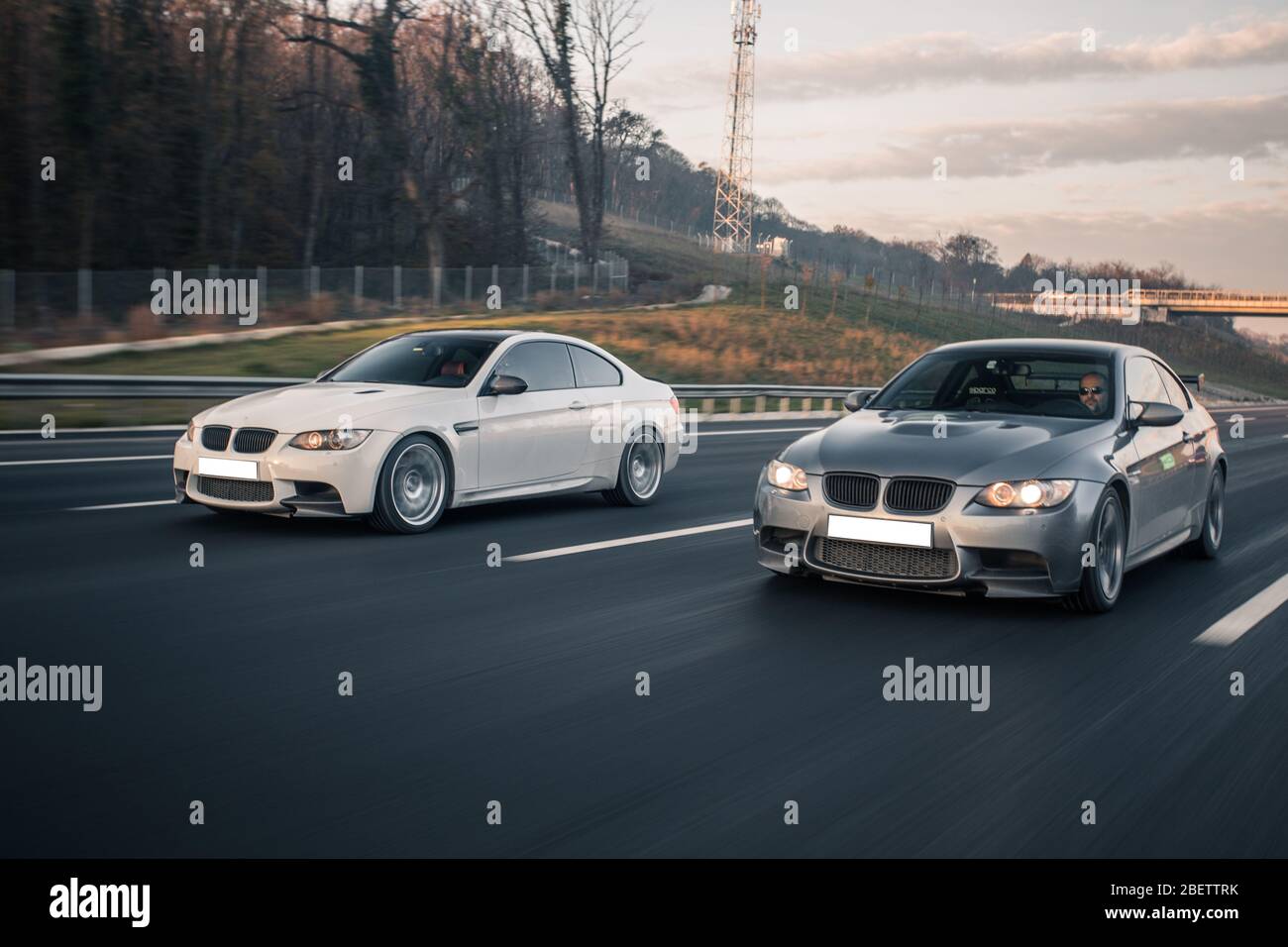 White and silver cars passing each other on the highway Stock Photo - Alamy