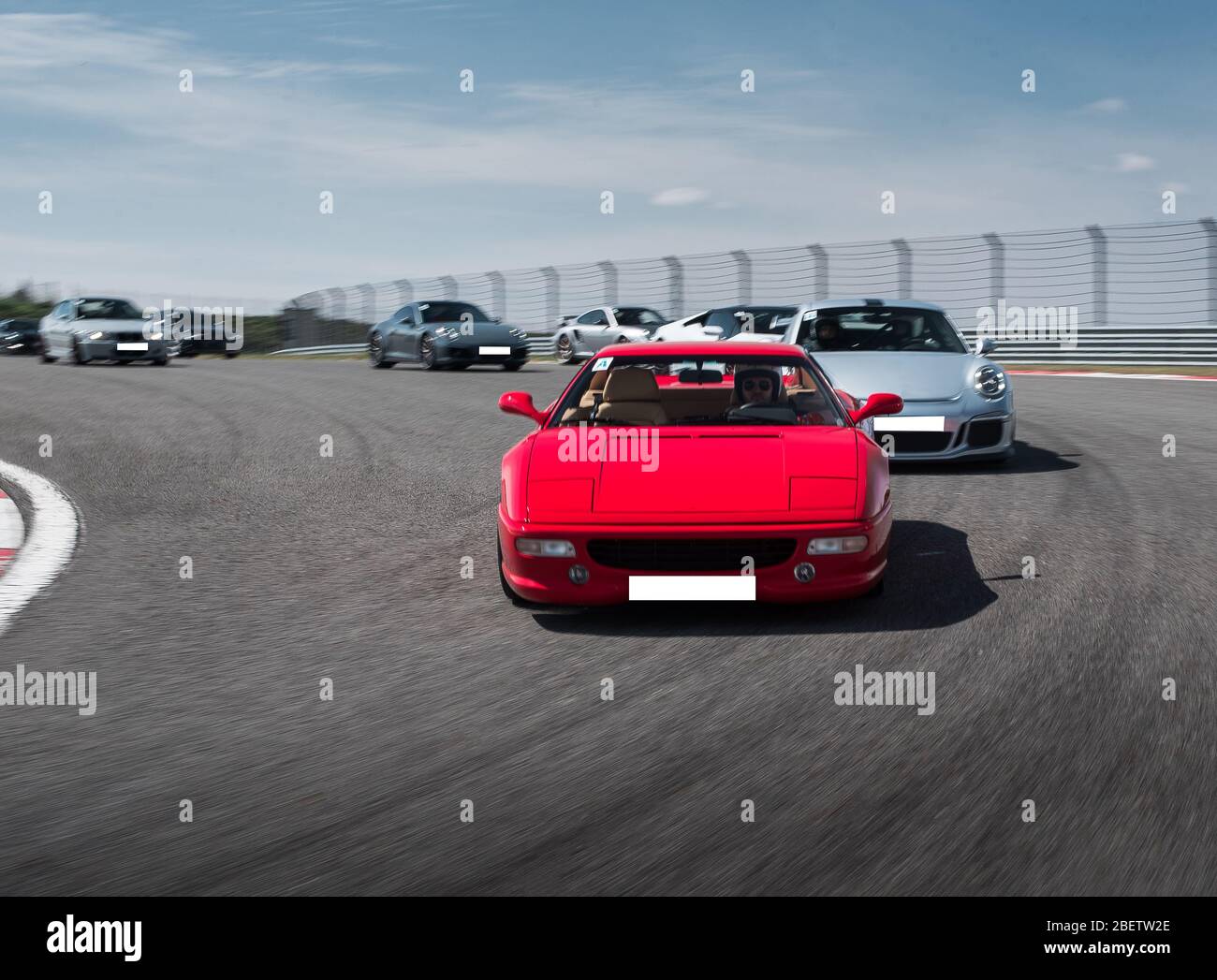 Red and blue sport cars racing on the highway with other cars Stock ...