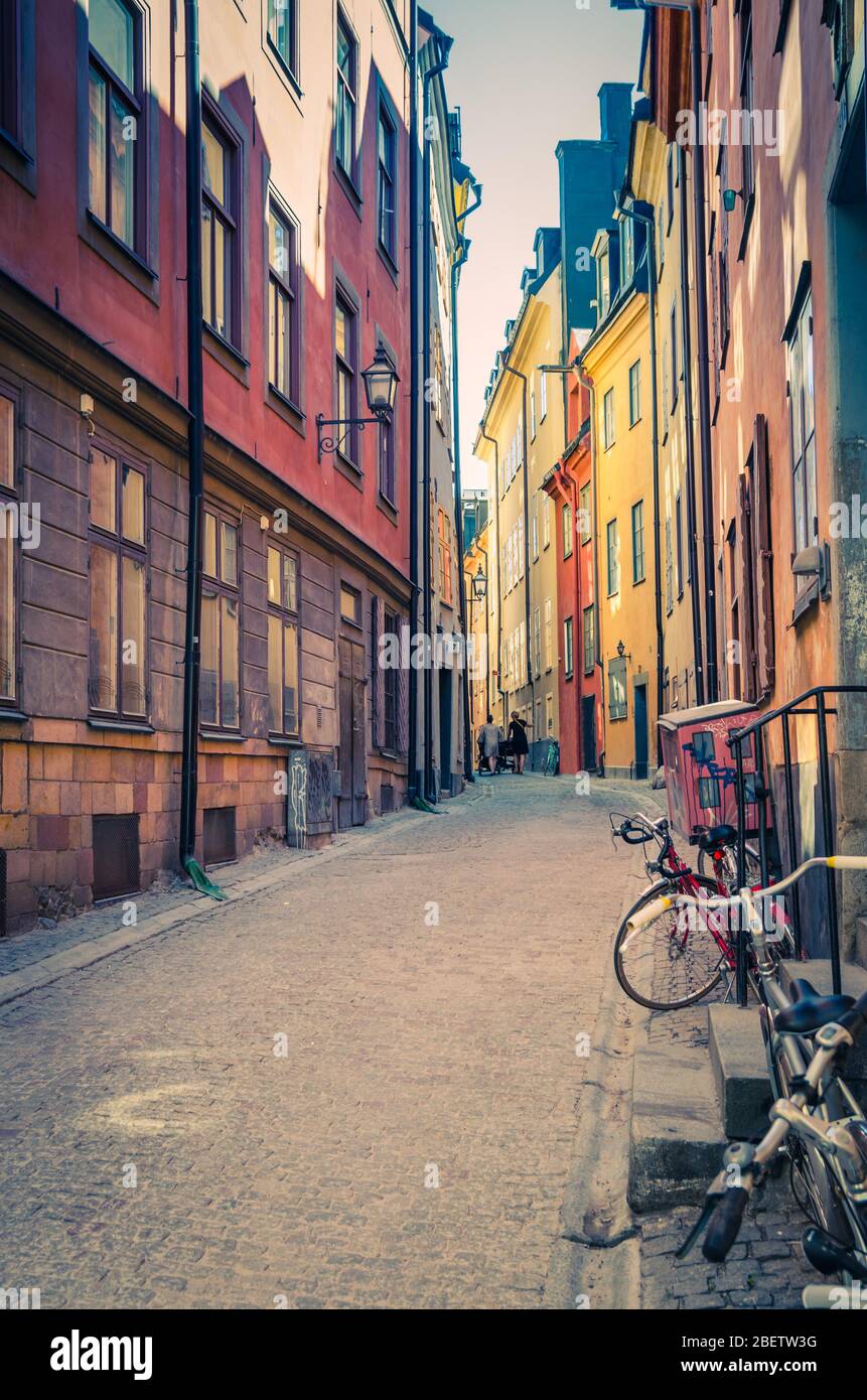 Traditional typical sweden narrow street with paving stones, bikes and ...