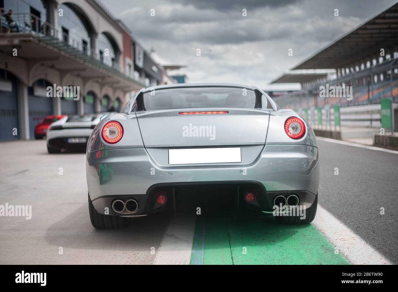 Back view of a silver sport car with red lights Stock Photo - Alamy