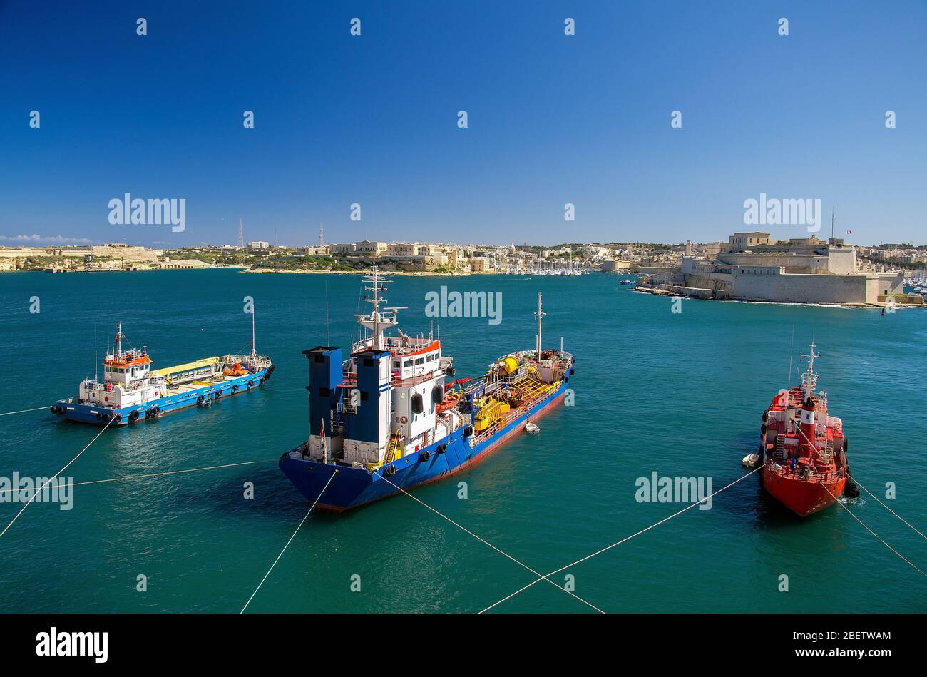 Three colourful cargo ships in the harbour of Valletta view from upper ...