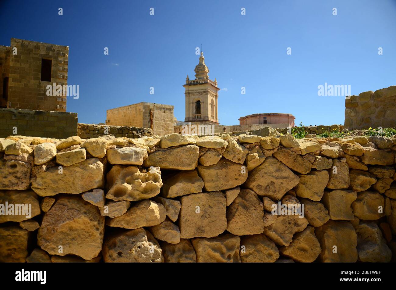View of brick stone yellow wall and the old medieval Cittadella tower ...