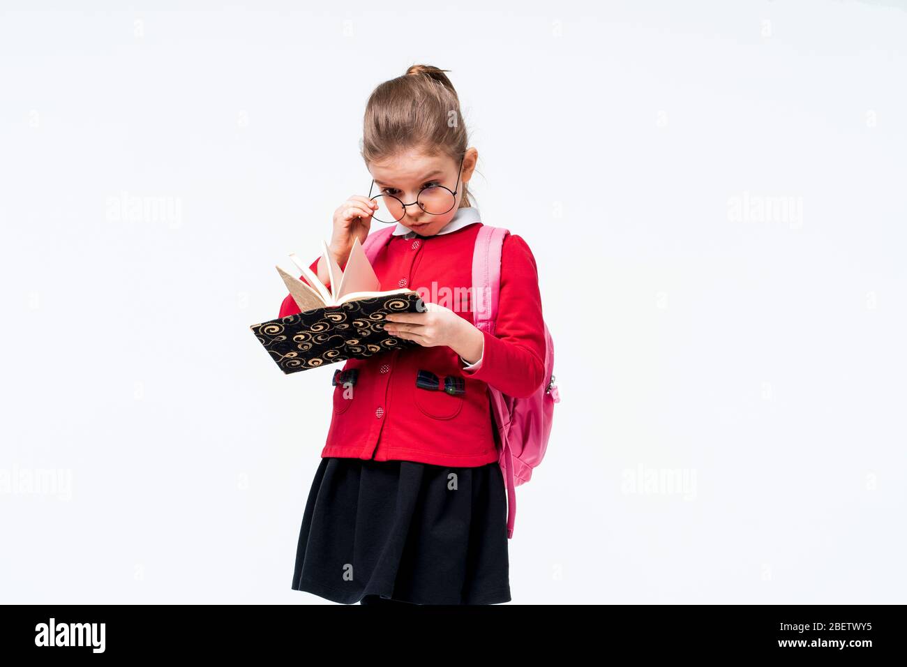 Adorable little girl in red school jacket, black dress, backpack and ...