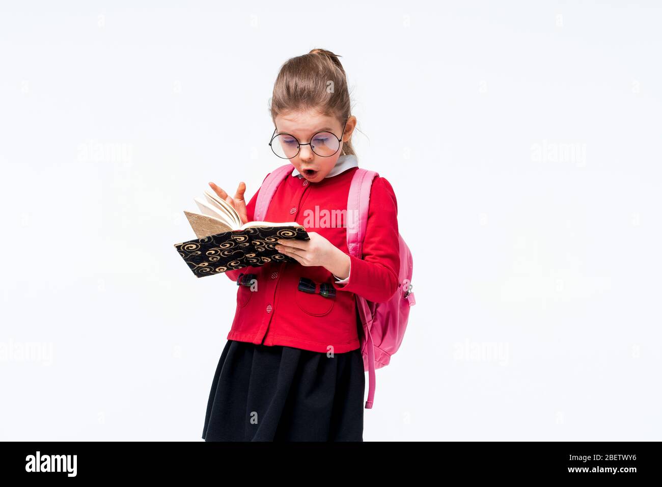 Adorable little girl in red school jacket, black dress, backpack and ...