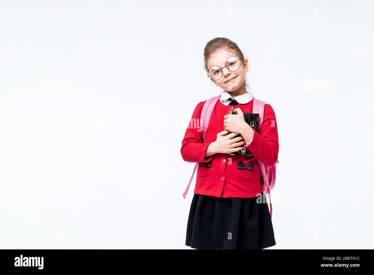 Adorable little girl in red school jacket, black dress, backpack and ...