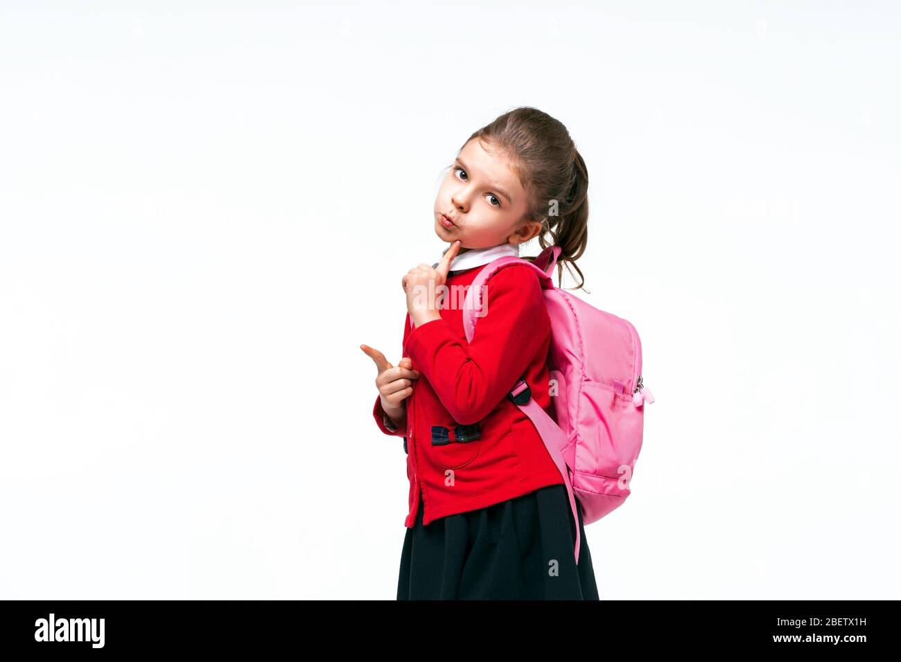 Adorable little girl in red school jacket, black dress, backpack ...