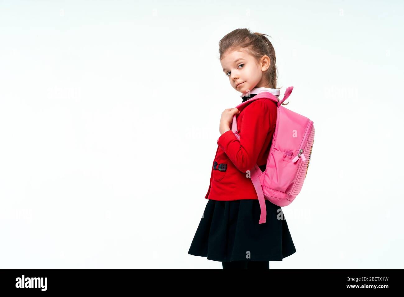 Adorable little girl in red school jacket, black dress, on to the ...