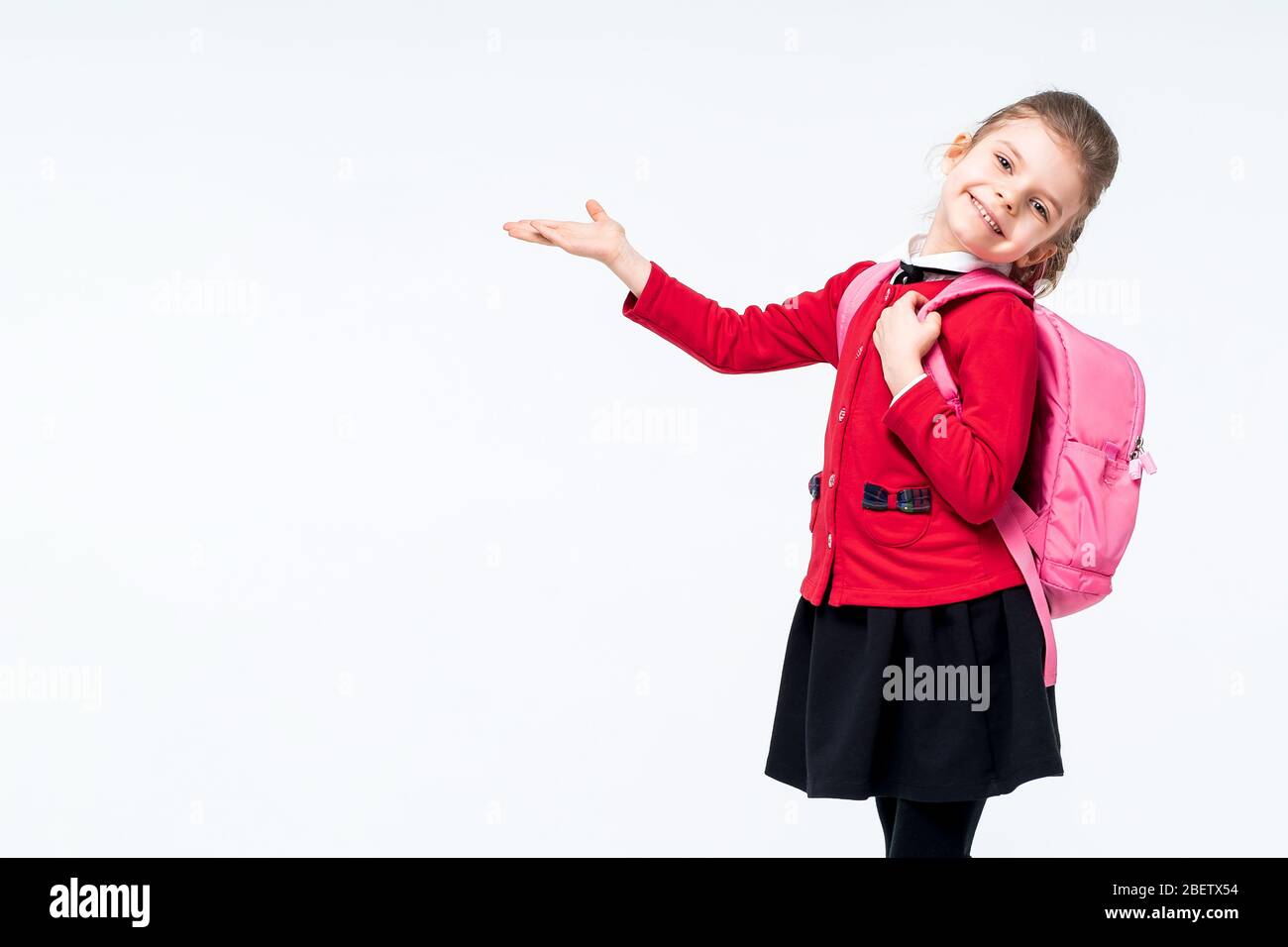 Adorable little girl in red school jacket, black dress, backpack ...