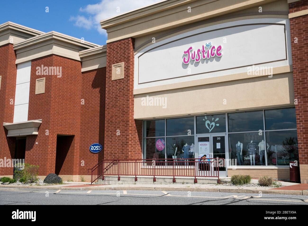A logo sign outside of a Justice retail store location in Mays Landing ...
