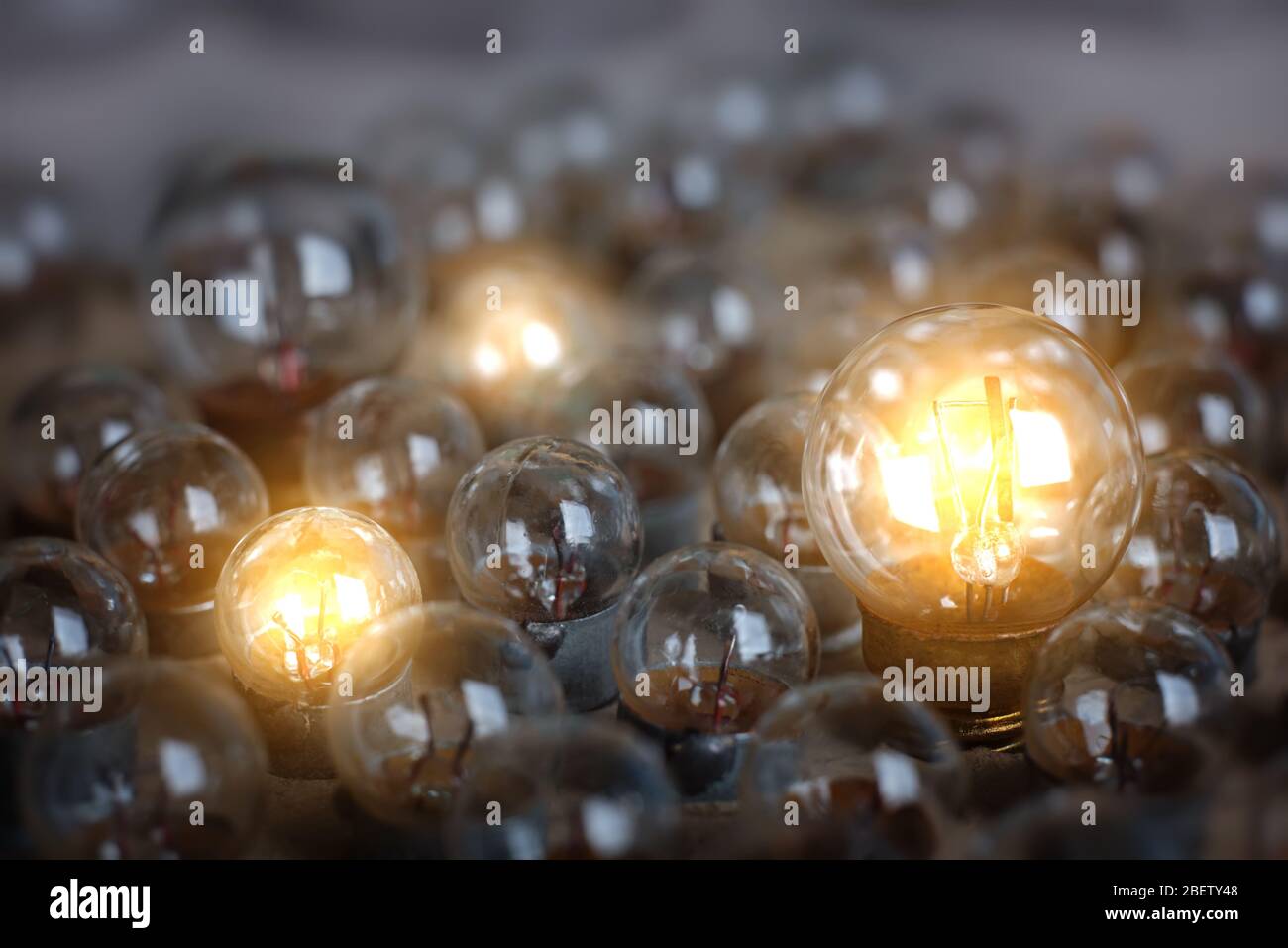 Many little light bulbs. Only a few are lighting. The concept of ...