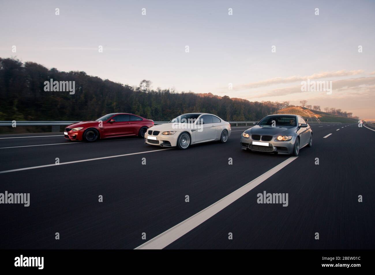 Three sport cars passing each other on the highway Stock Photo - Alamy