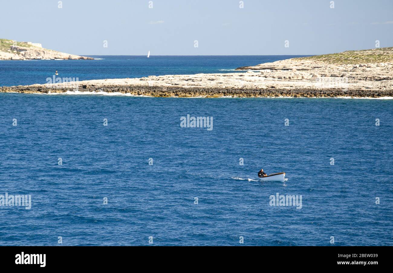 Fishing boat near the island of Comino or Kemmuna of the Maltese ...