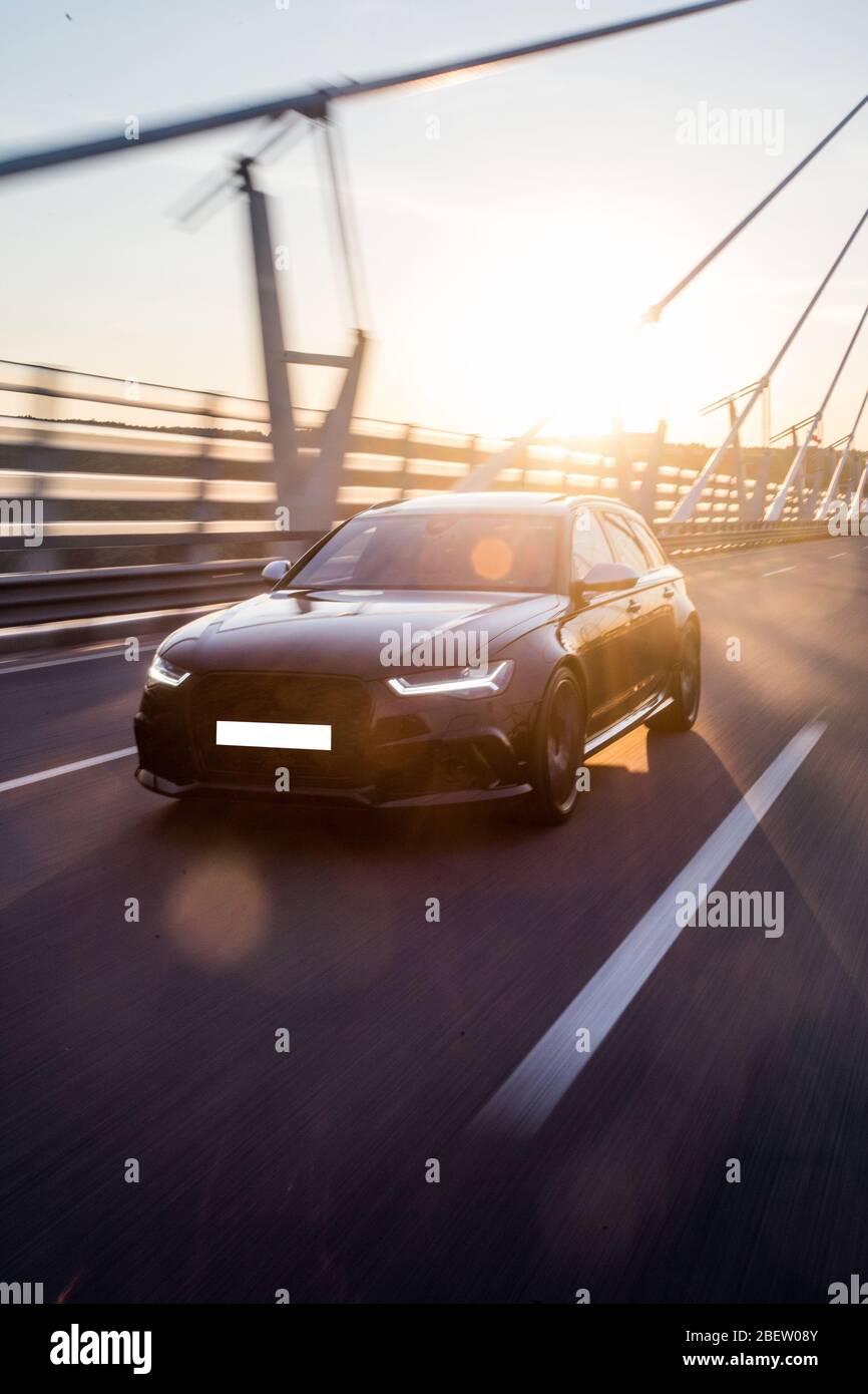 Black sedan car on the design modern bridge under the sunlight Stock ...