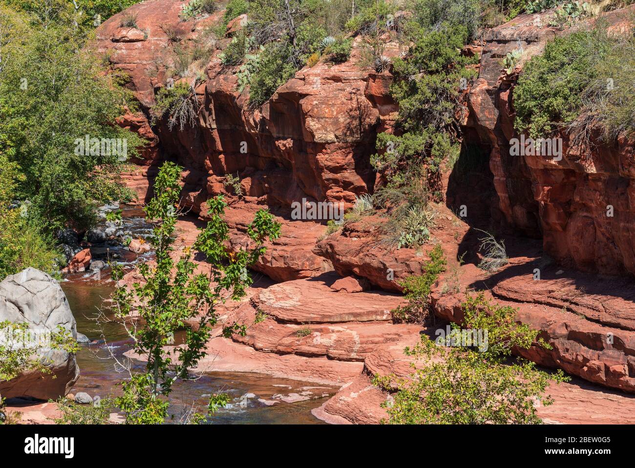 High angle landscape of jagged colorful red rock formations and water ...