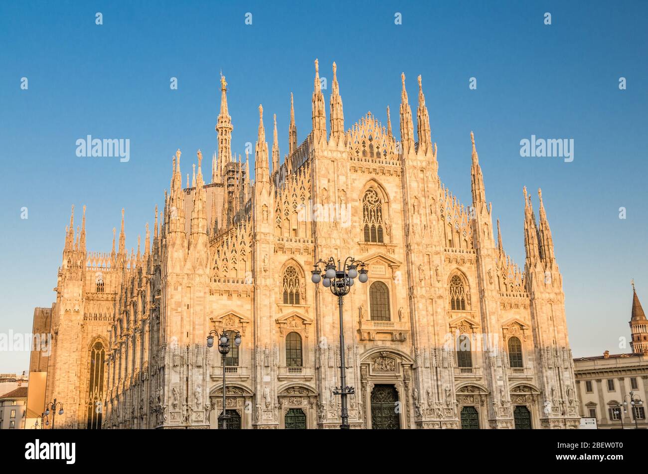 Duomo di Milano cathedral facade with white walls, high windows, spires ...
