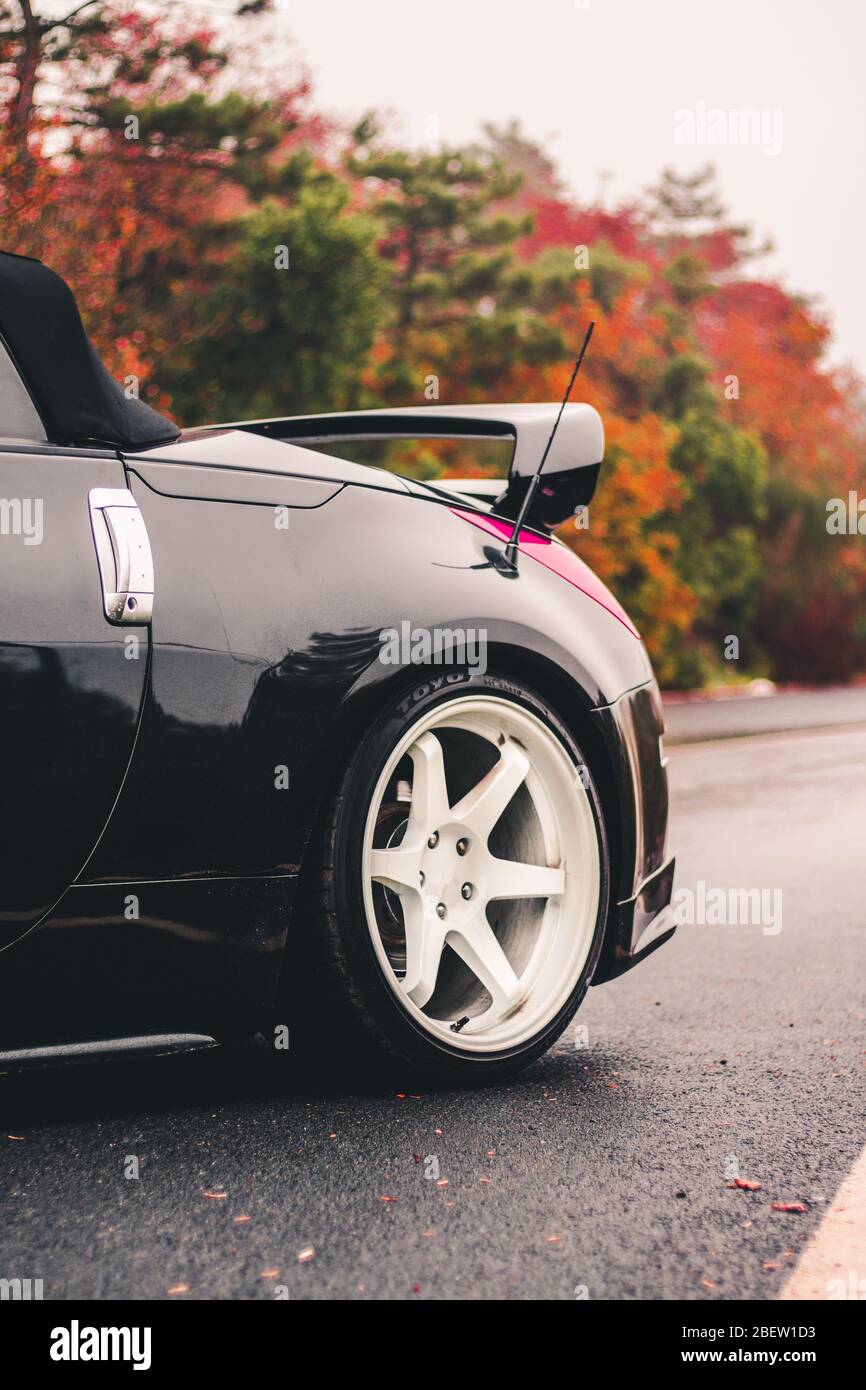 Back silver design wheel and lights of a black car Stock Photo - Alamy
