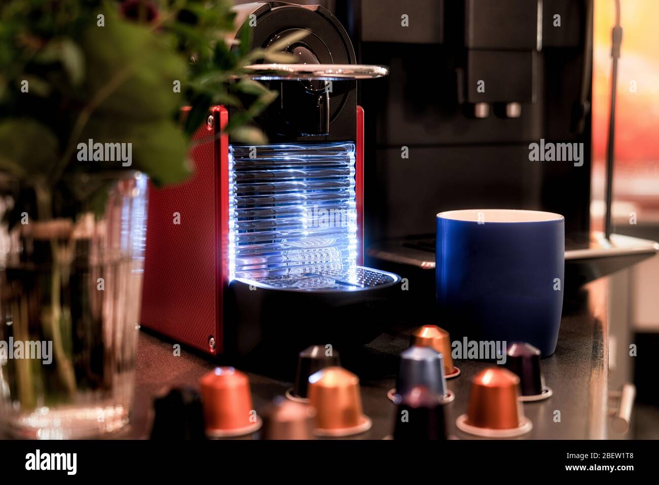 Red Blue Glowing Coffee Machine with Capsules in the Foreground Stock ...
